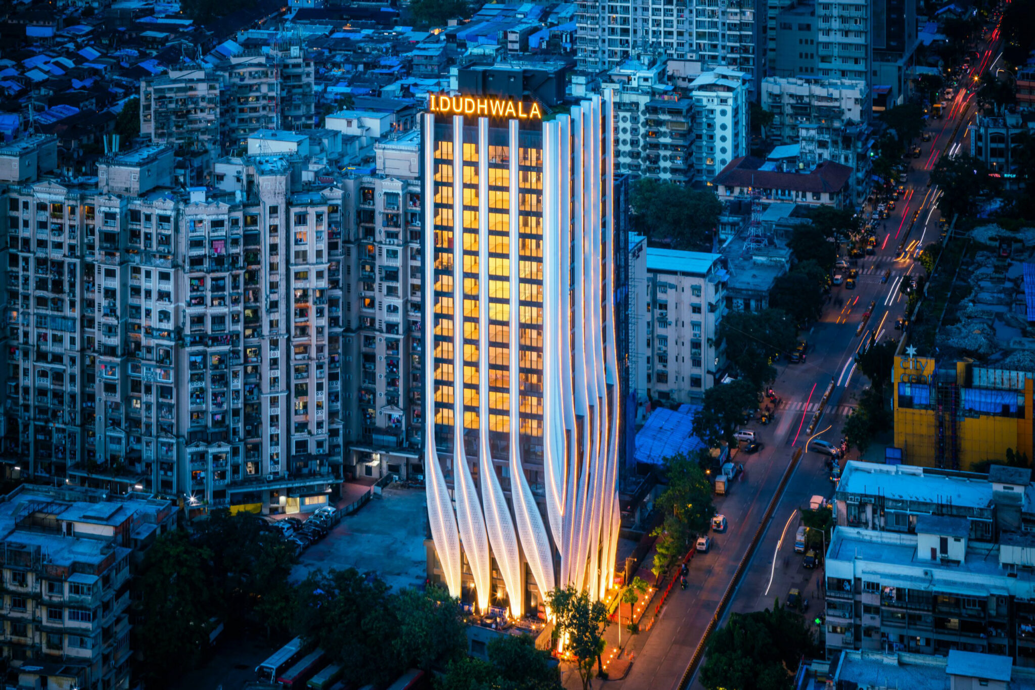 studio symbiosis clads tower in mumbai with calligraphic strokes