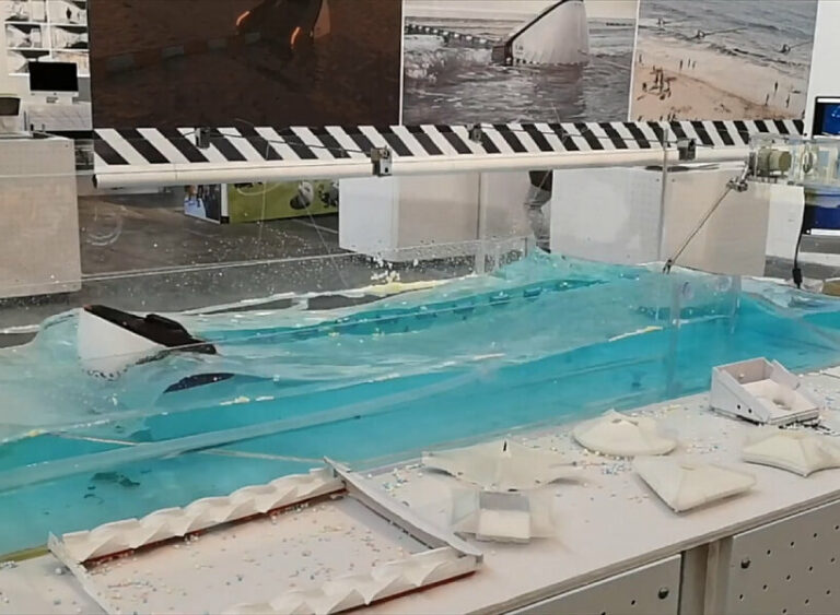 garbage collector by student scoops ocean trash with waves