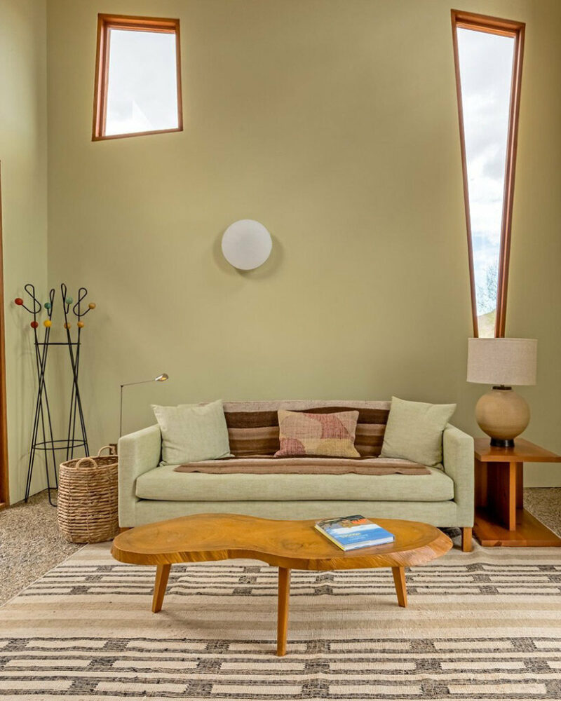 emerging from the rugged joshua tree desert, colorful 'monument house ...