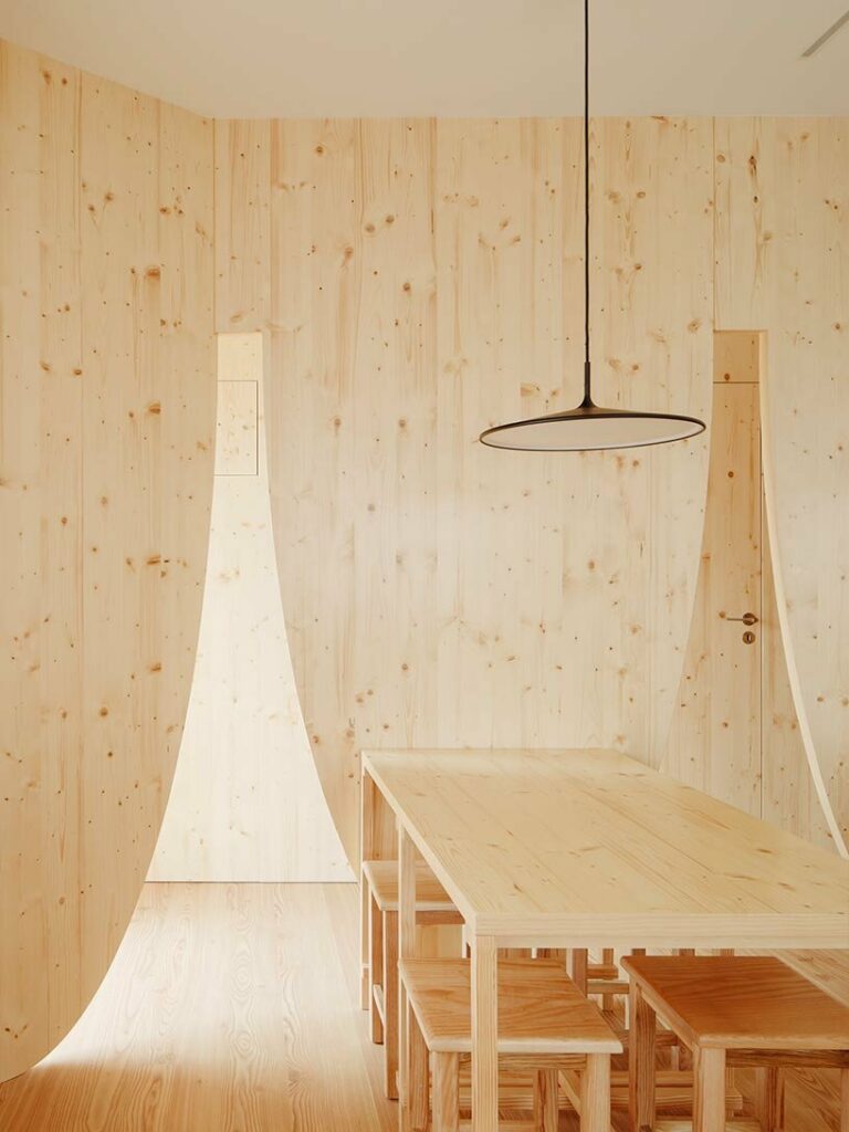 funnel-shaped cutouts finish snug restaurant in portugal