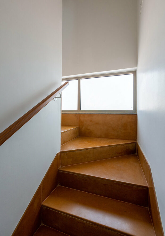 deep red-terracotta screens bring dynamic porosity to 'house on 46'