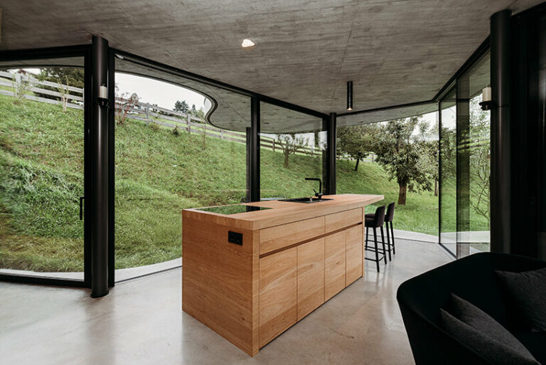 grassy 'freiform' house is embedded into the tyrolean landscape