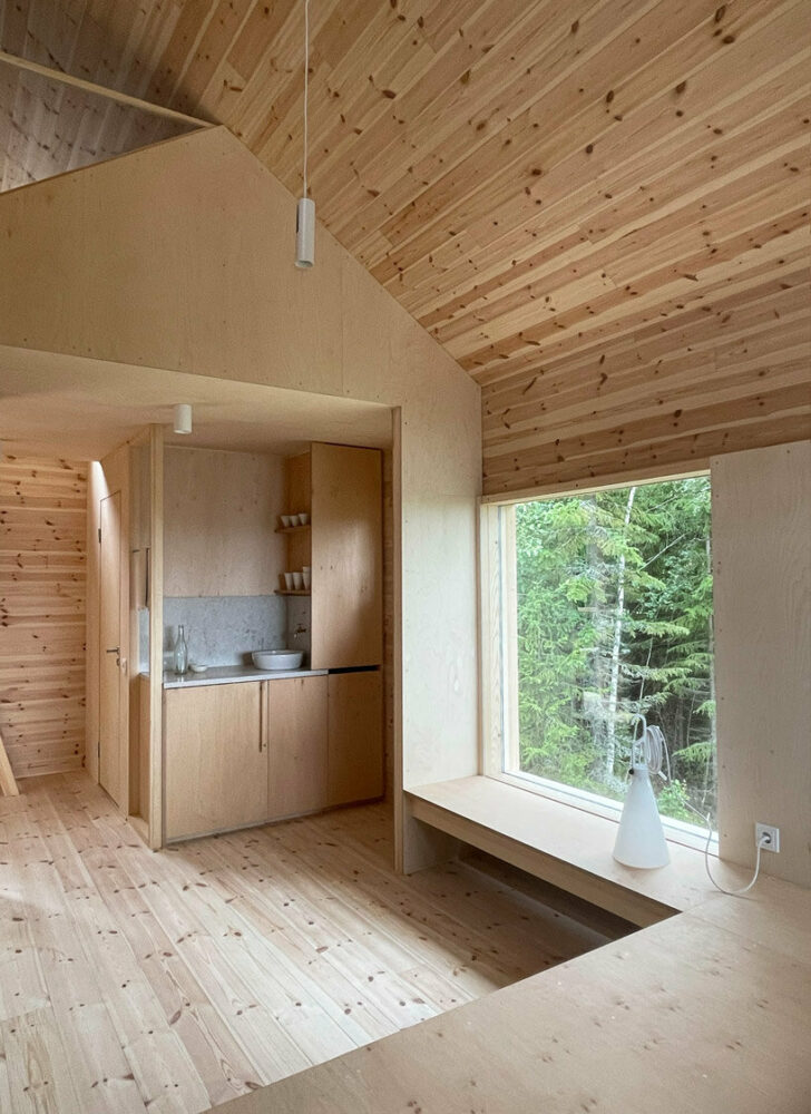 wooden cabin on stilts is perched on mountainous scenery in sweden