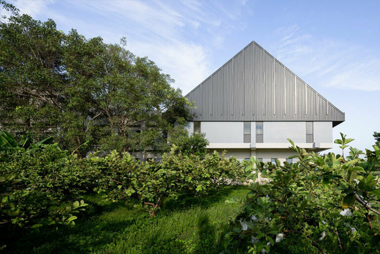 triangular metal roof crowns elevated sports hall in taiwan school ...