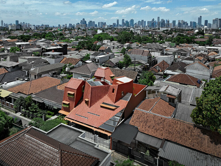 distracted house adorns a quirky roof composition in indonesia