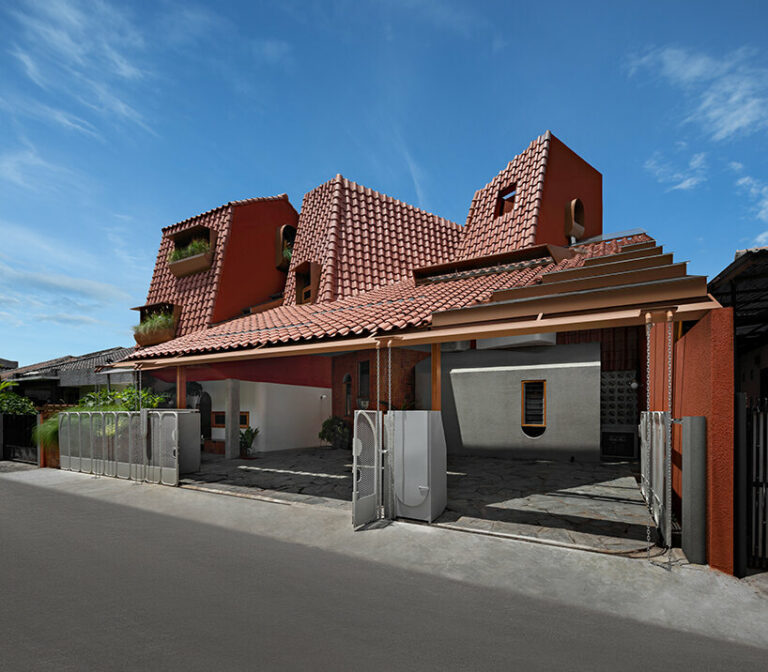 distracted house adorns a quirky roof composition in indonesia