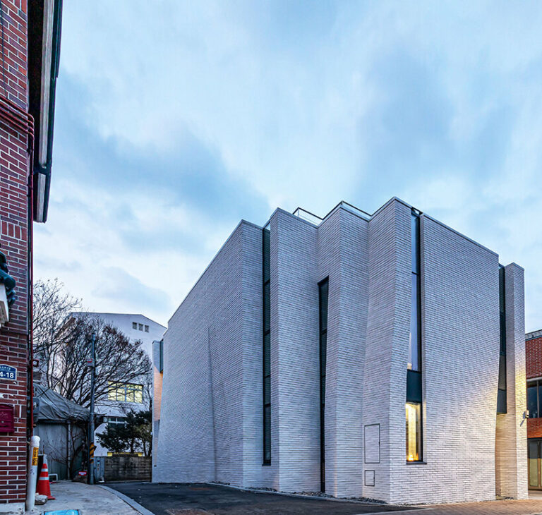 a curved brick wall ripples across LESS architects' office building ...