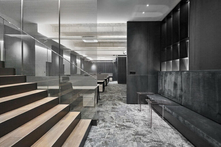 a curved brick wall ripples across LESS architects' office building ...