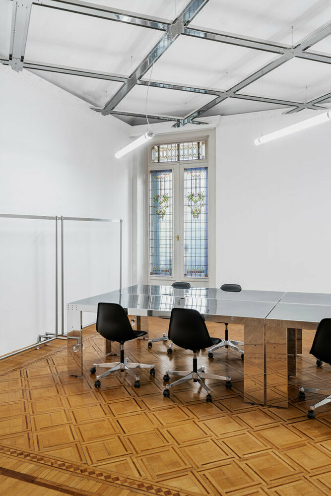 NM3 finishes reference studios' milanese showroom with stainless steel ceiling and furniture