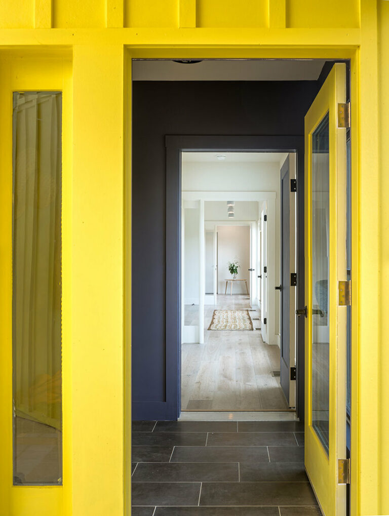 a dramatic yellow void defines 'oblong farm' by scalar architecture