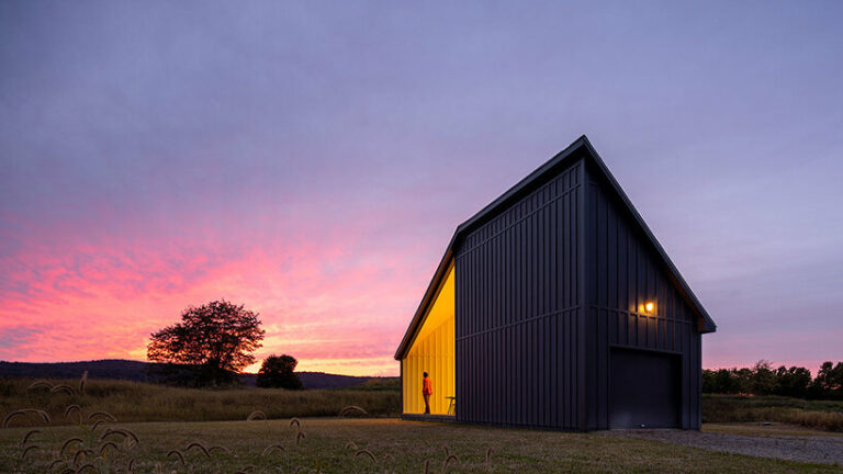 a dramatic yellow void defines 'oblong farm' by scalar architecture