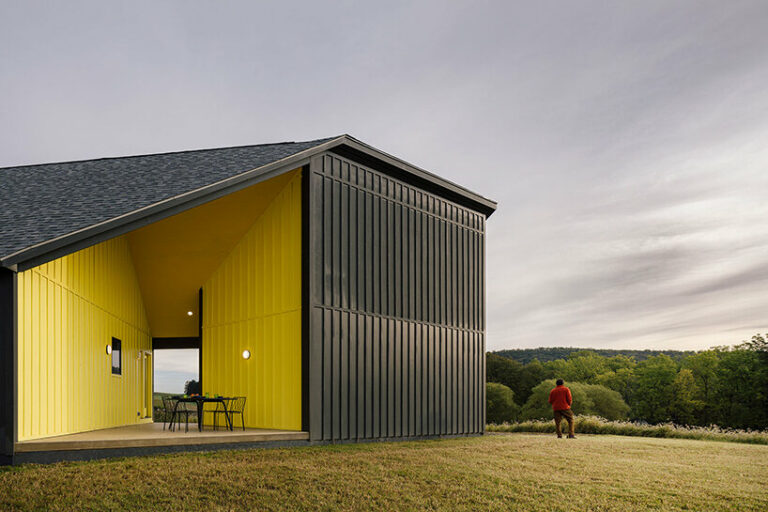 a dramatic yellow void defines 'oblong farm' by scalar architecture