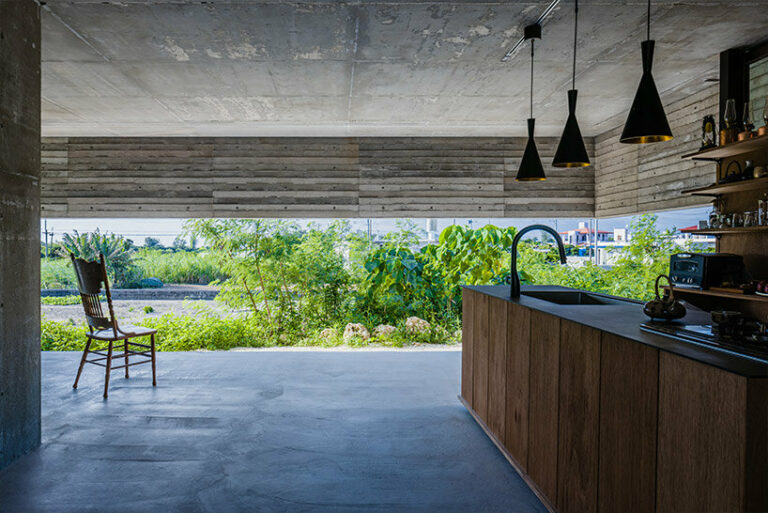 house in japan extends around a single column like an open umbrella