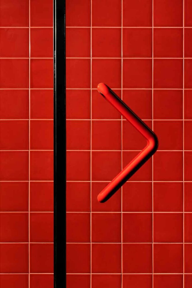 glossy red tiles dynamically contrast with lime green counter within ...