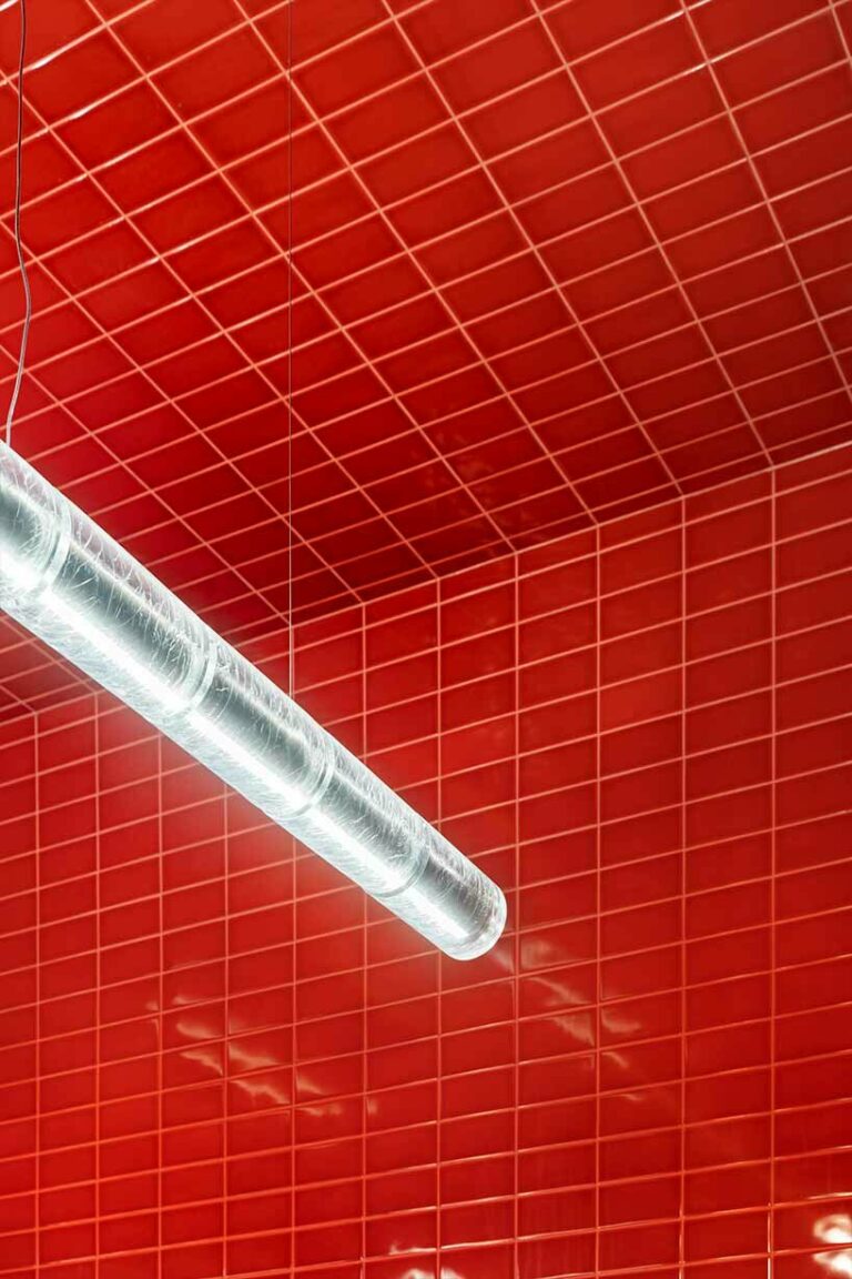 glossy red tiles dynamically contrast with lime green counter within ...