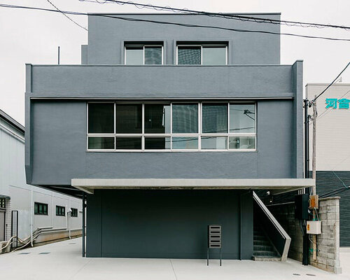 a reflective zigzag façade clads OHArchitecture's factory in awaji, japan
