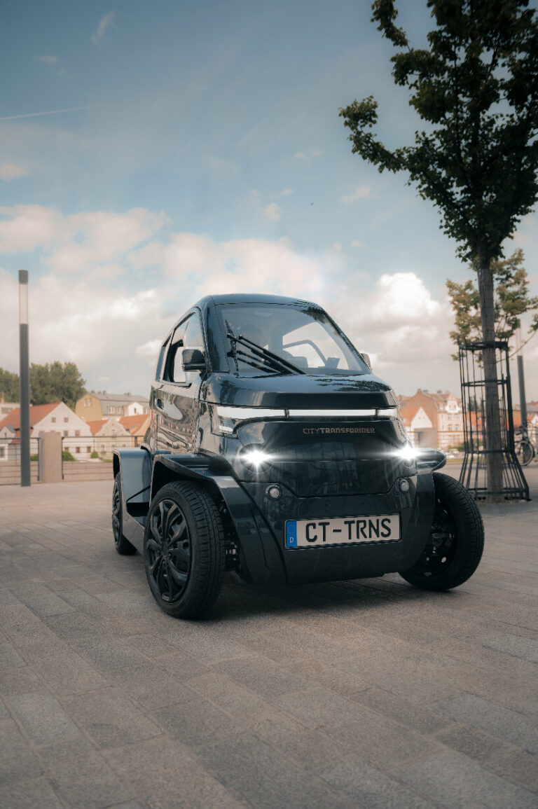 electric microcar retracts wheels to easily park and ride in narrow ...