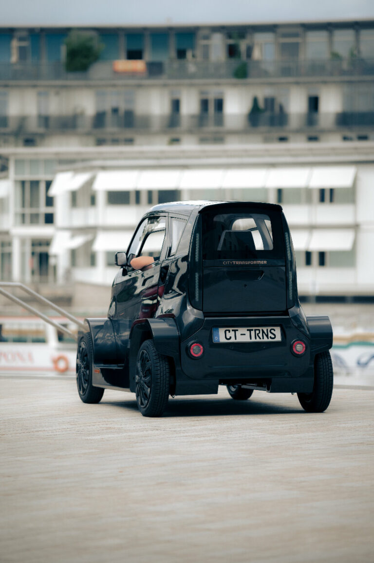 electric microcar retracts wheels to easily park and ride in narrow ...