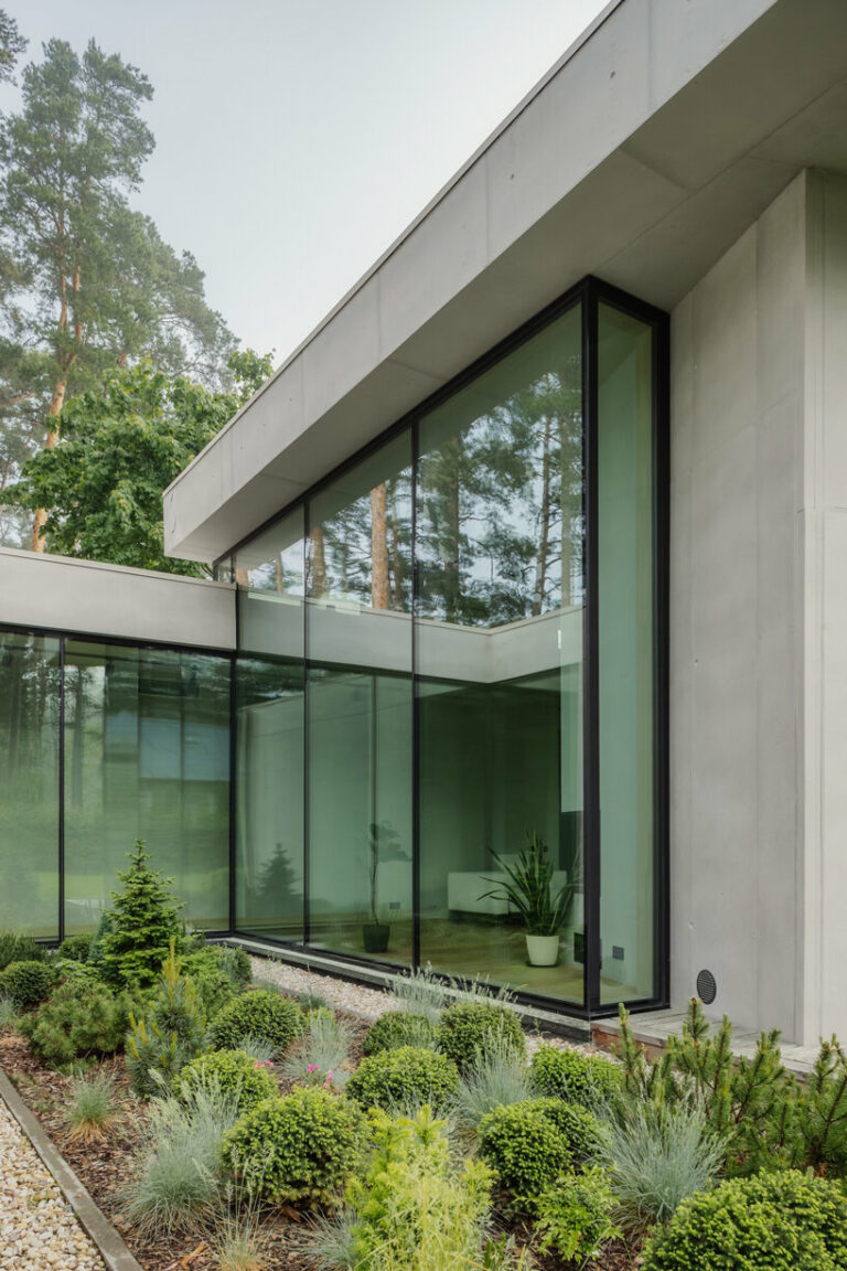 concrete residence in latvia unfolds two distinct dynamic volumes