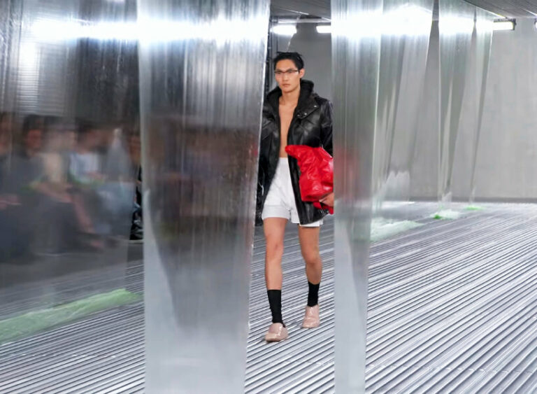 in prada SS24 ‘fluid form’ show, translucent thick slime cascades like luminous resin waterfall