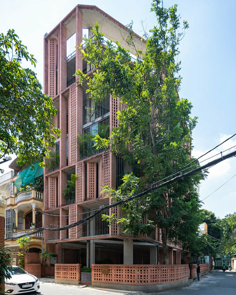 tropical space encloses 'premier office' with a porous brick facade