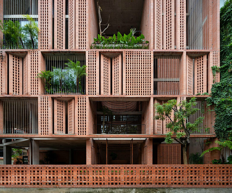 tropical space encloses 'premier office' with a porous brick facade