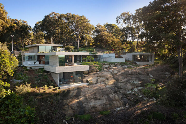 bunkeren house: half-buried volumes integrate with sloping site in ...