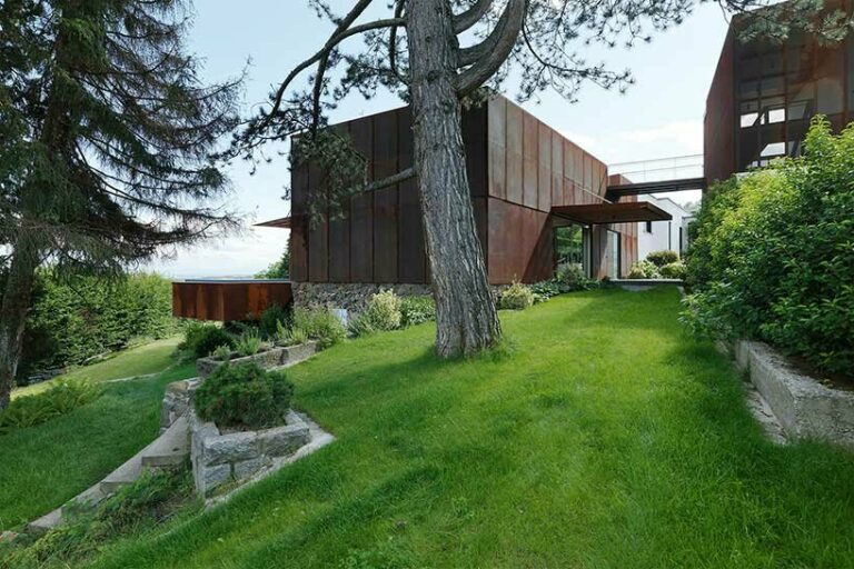 trio of rusted steel volumes forms 'deconstructed house' in austria