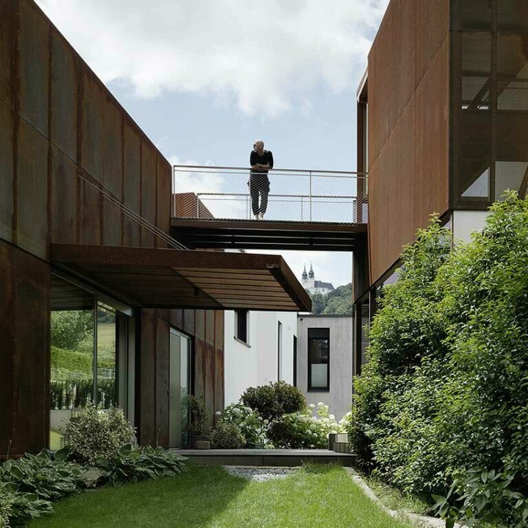trio of rusted steel volumes forms 'deconstructed house' in austria