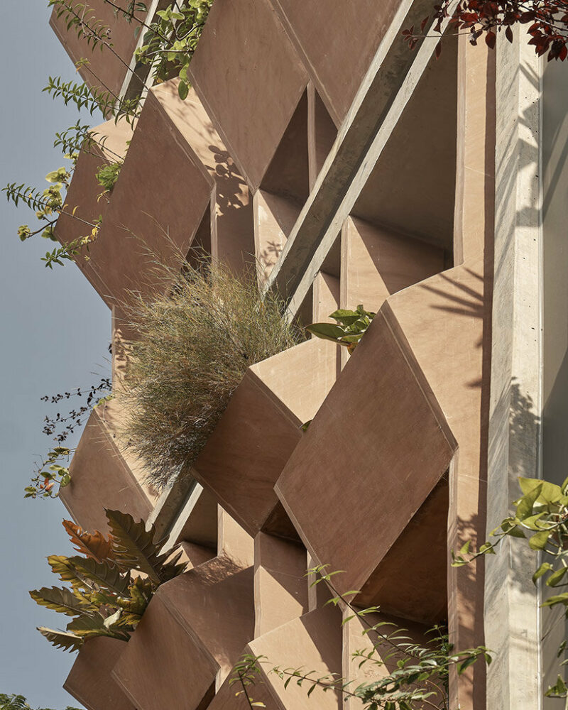 workspaces in india are wrapped in a living facade of stone planters