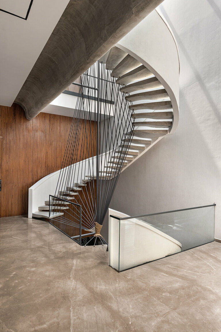 concrete ribbon wraps around studio ardete's residence in india