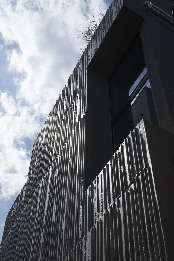 K+S architects fronts home-office with striated concrete texture