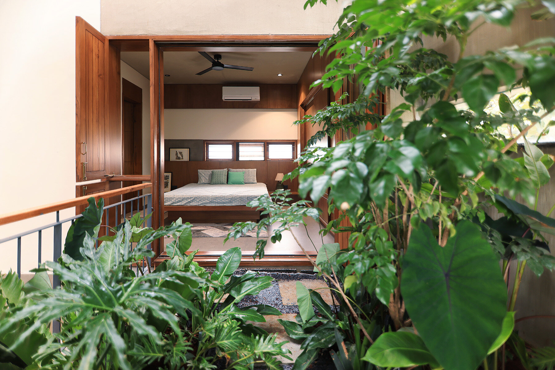a threshold's green-filled 'ineffable light' house in bangalore
