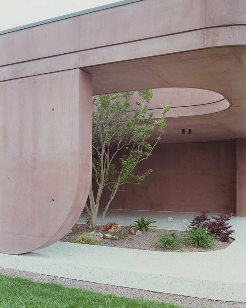 MIDE architetti's pink concrete residence curves around lush vegetation ...