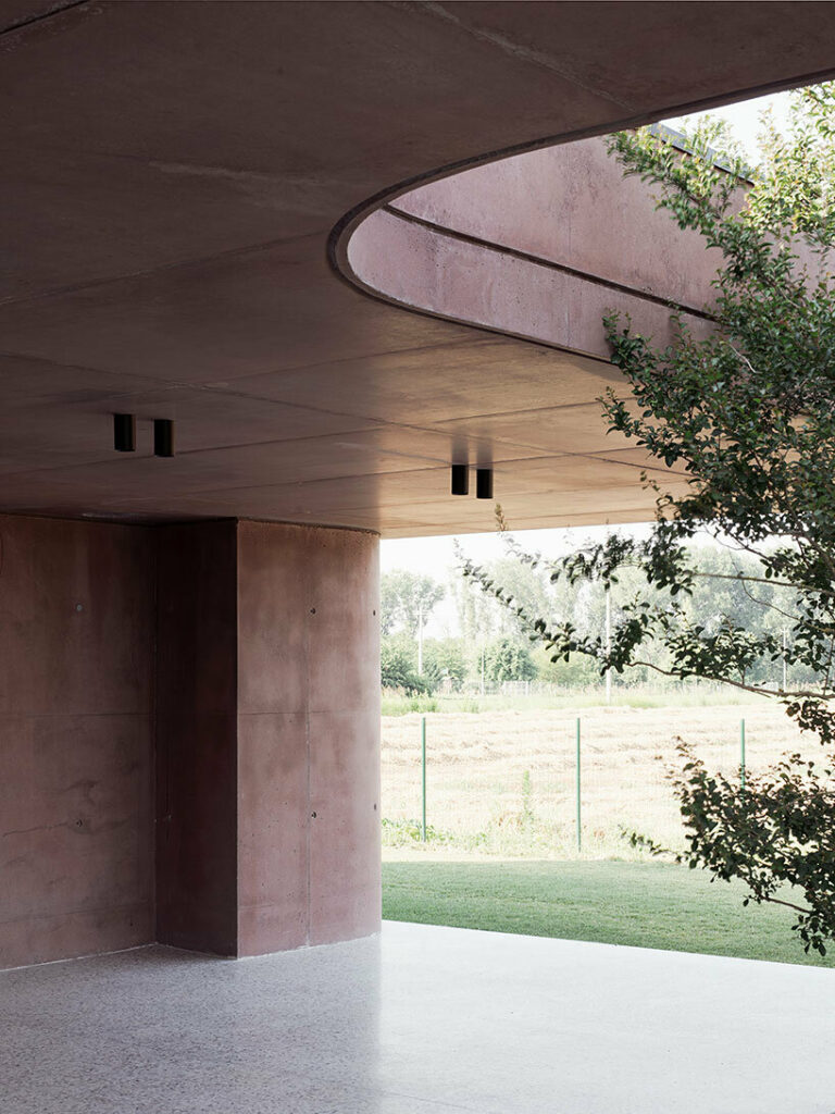 MIDE architetti's pink concrete residence curves around lush vegetation ...