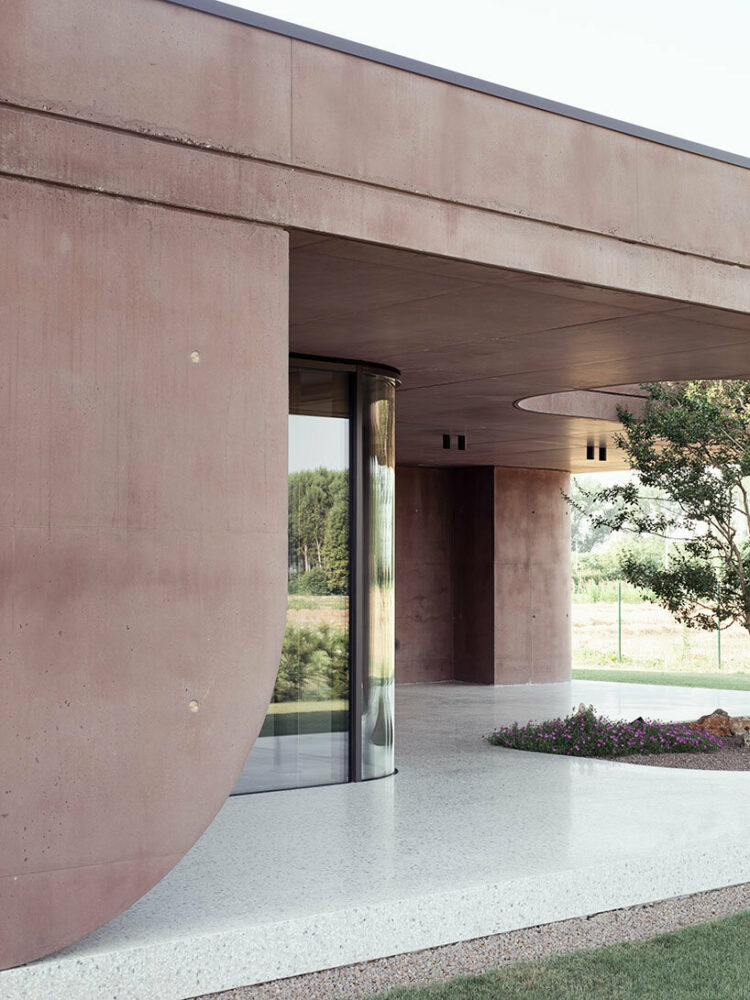 MIDE architetti's pink concrete residence curves around lush vegetation ...