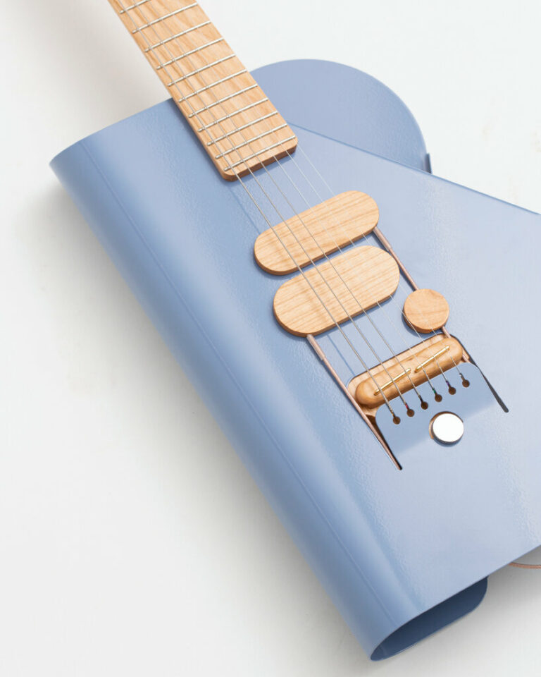 cosmo electric guitar wraps bent luminous metal sheet around its wooden ...