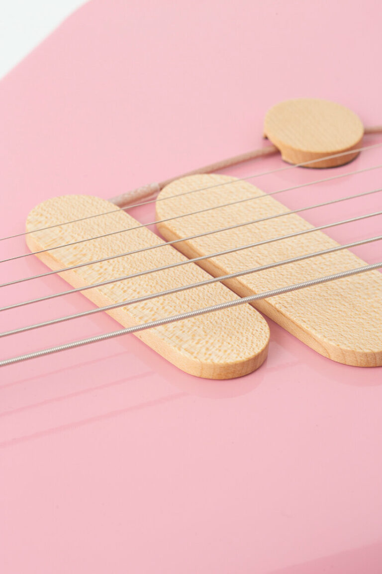 cosmo electric guitar wraps bent luminous metal sheet around its wooden ...