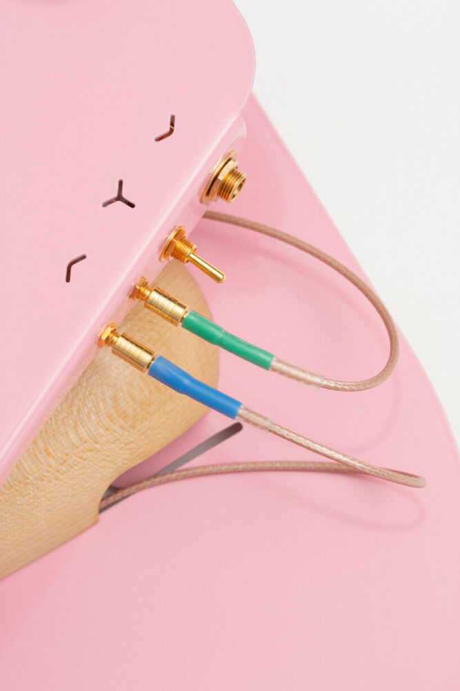 cosmo electric guitar wraps bent luminous metal sheet around its wooden ...