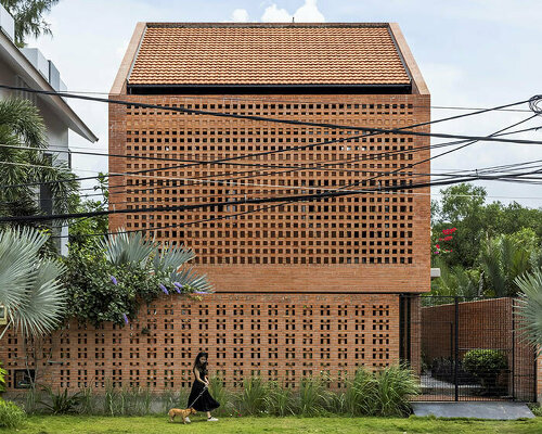 tropical space encloses 'premier office' with a porous brick facade