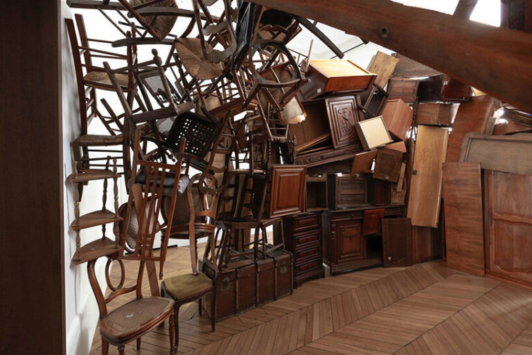 tadashi kawamata nests a tower of chairs onto liaigre's facade