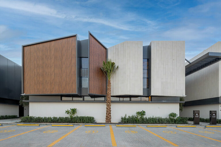timber-clad and concrete boxes compose courtyard houses in saudi arabia