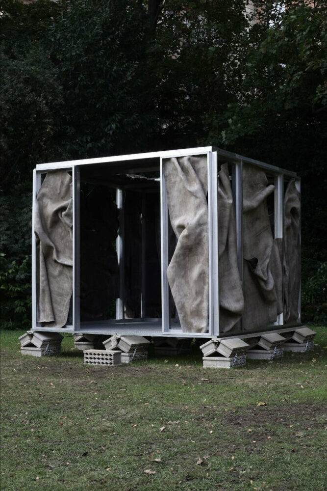 crumpled cement drapes over function-free pavilion X in paris