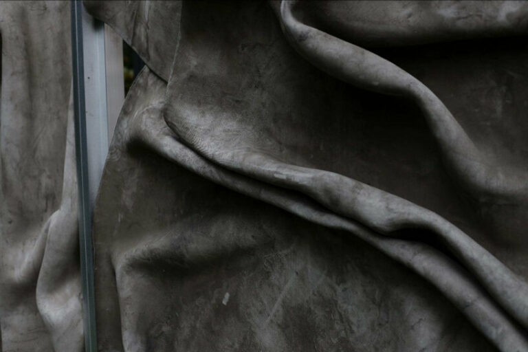 crumpled cement drapes over function-free pavilion X in paris