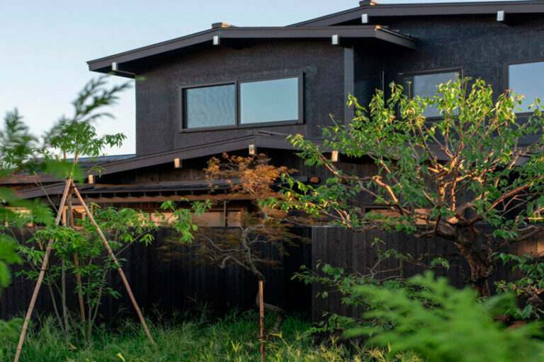 old japanese farmhouse transforms into modest hotel with U-shaped gardens