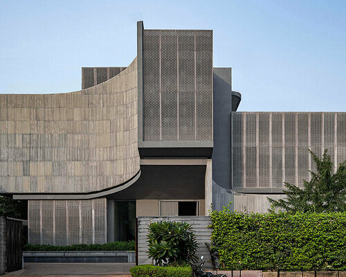 a cluster of open spaces woven with nature shape home in india