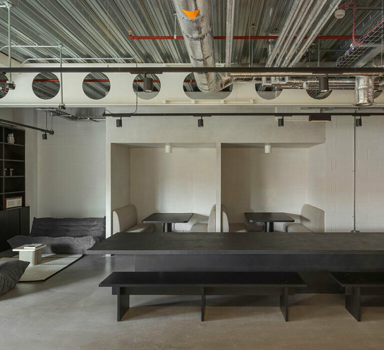 holloway li weaves sculptural steel staircase into monolithic workspace in the UK