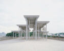undulating canopy by new office works shelters waterfront promenade in hong kong