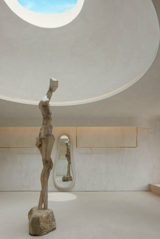 sculpture and tree pierce oculi of sugarhouse's miami fashion store