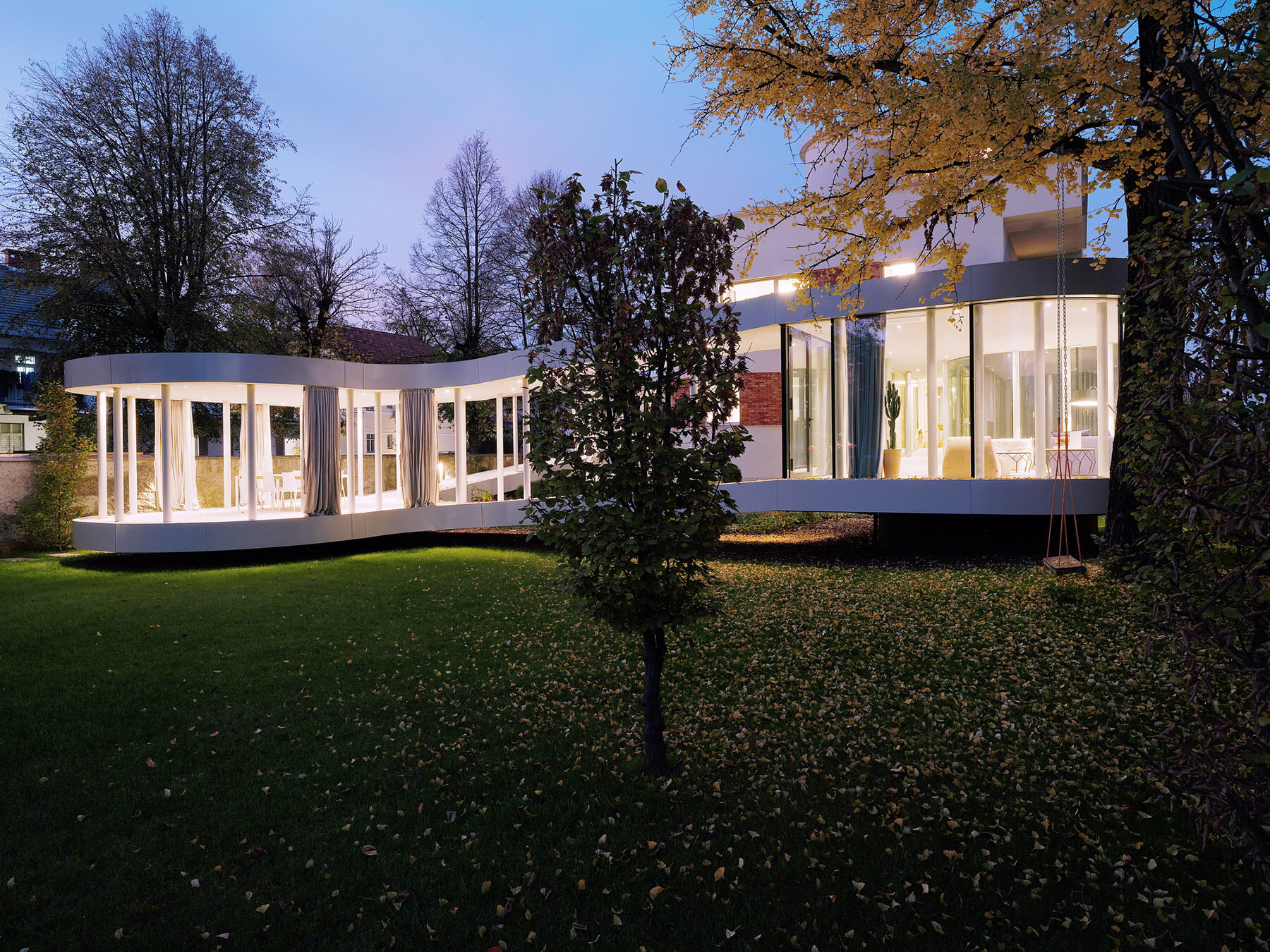 OFIS uplifts 1930s ring house with a floating pavilion in slovenia